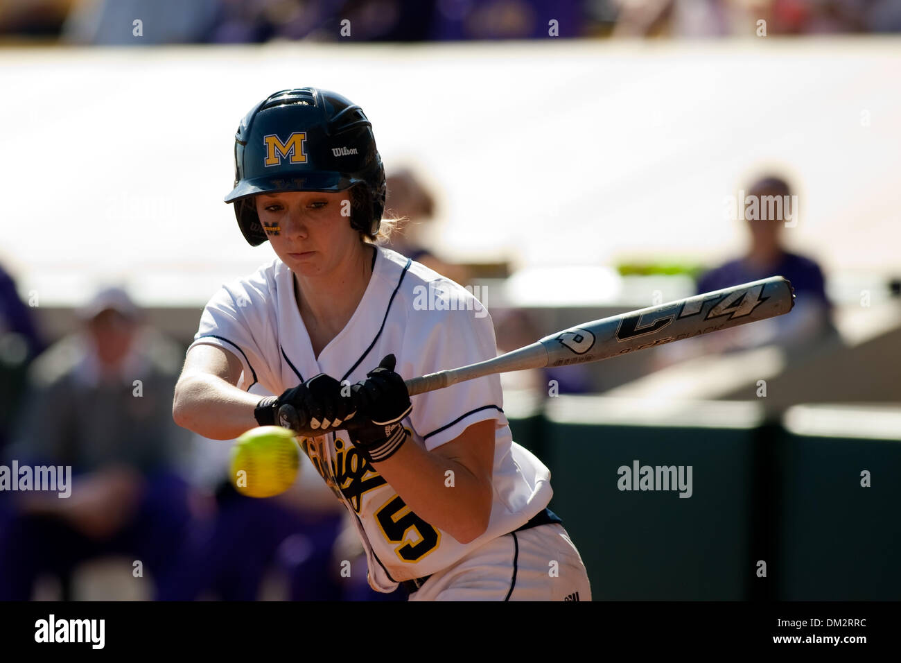 Centenary at LSU; Michigan infielder Bree Evans attempts a slap hit ...