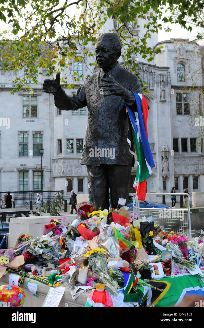 Tributes to Nelson Mandela at his statue at Parliament Square in London ...