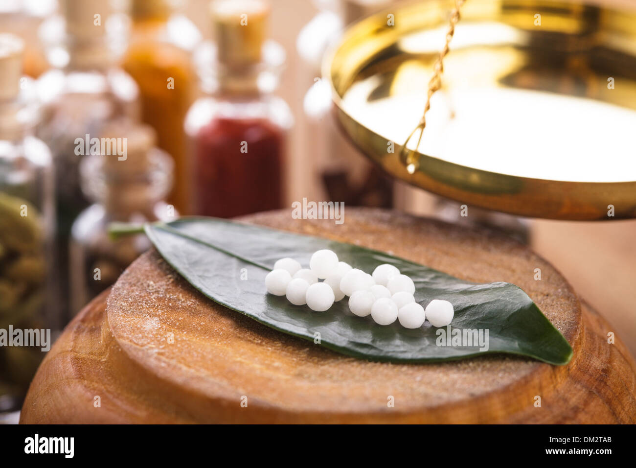 Homeopathy pills on the green leaf closeup Stock Photo - Alamy