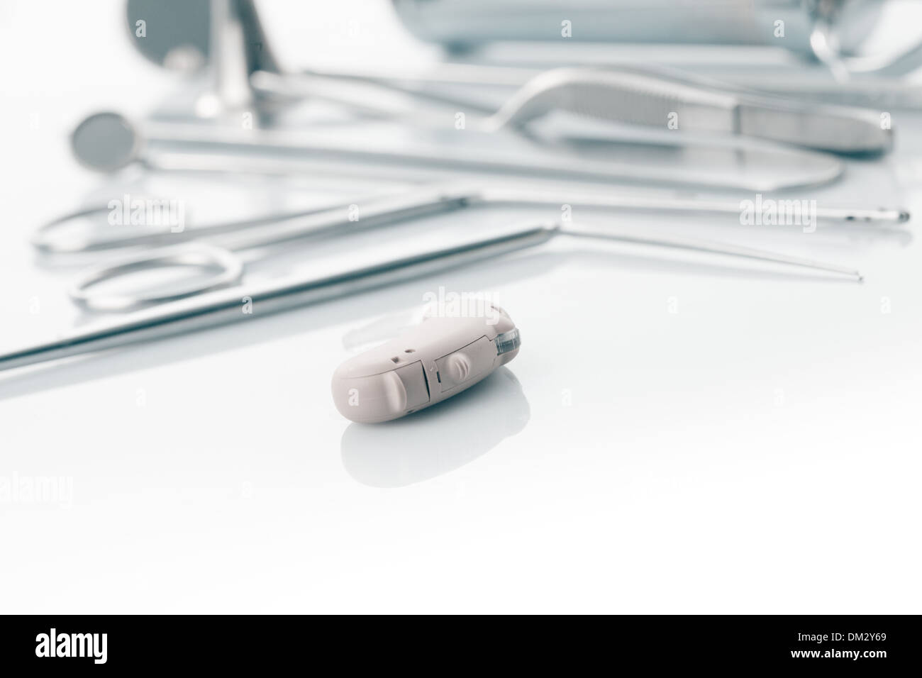 Medical instruments for ENT doctor on white and hearing aid ...