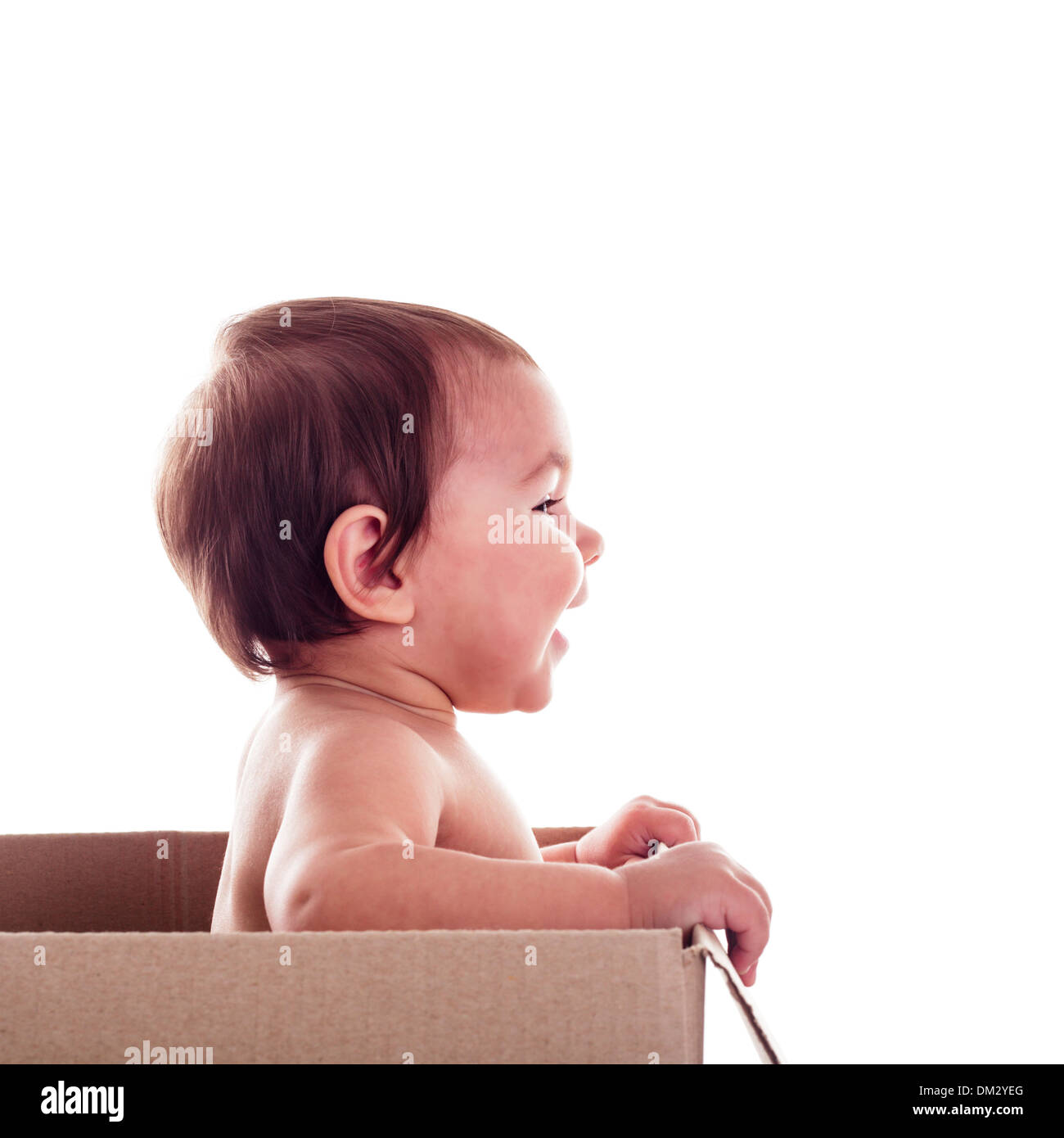 A small child (baby) in the box isolated, side view Stock Photo - Alamy