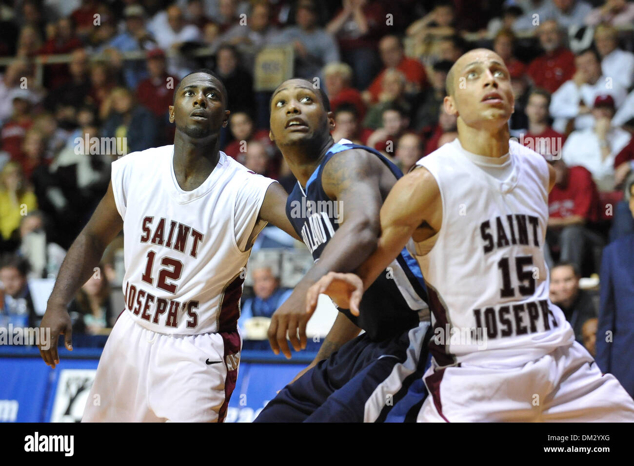 Villanova Guard Corey Stokes #24 is sandwiched St. Josephs Guard Justin ...