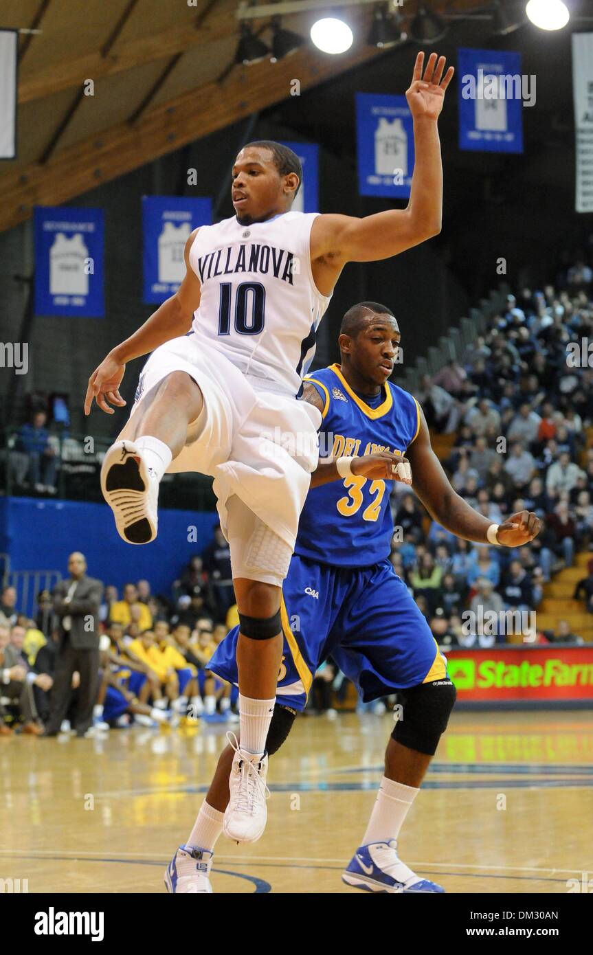 Villanova guard Corey Fisher #10 is flying past Delaware forward Josh ...