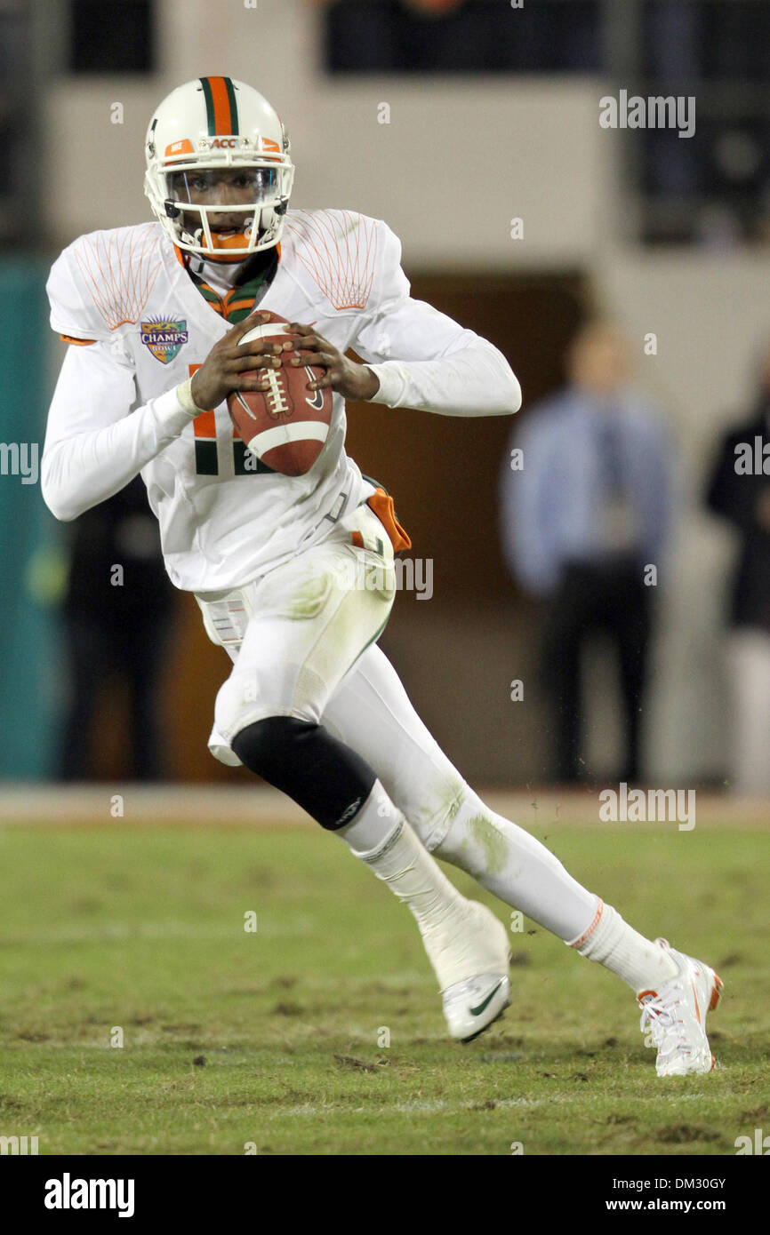 Miami (FL) quarterback Jacory Harris (12) scrambles of of the pocket ...