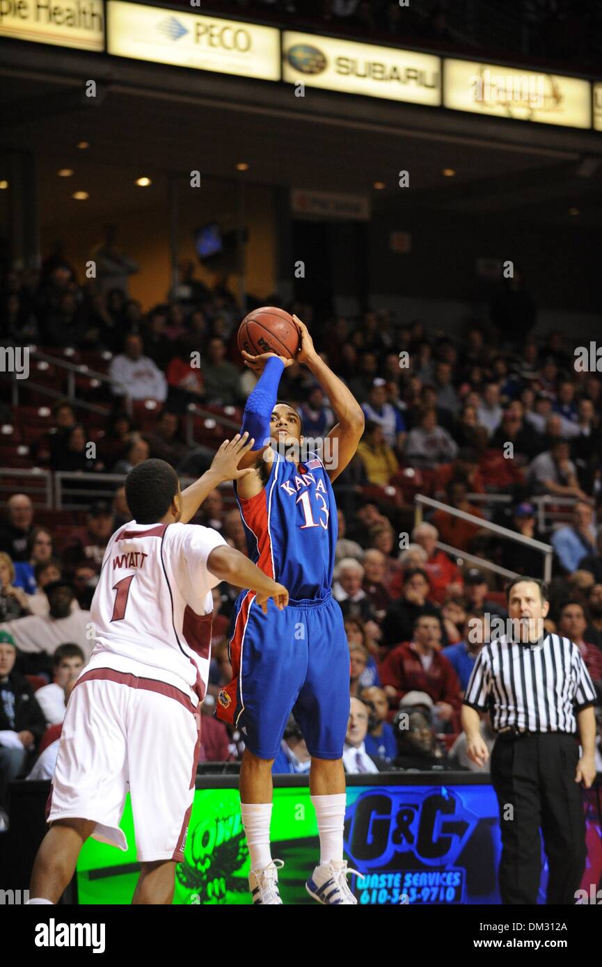 Kansas guard C.J. Henry #13 shoots a three pointer over Temple guard ...