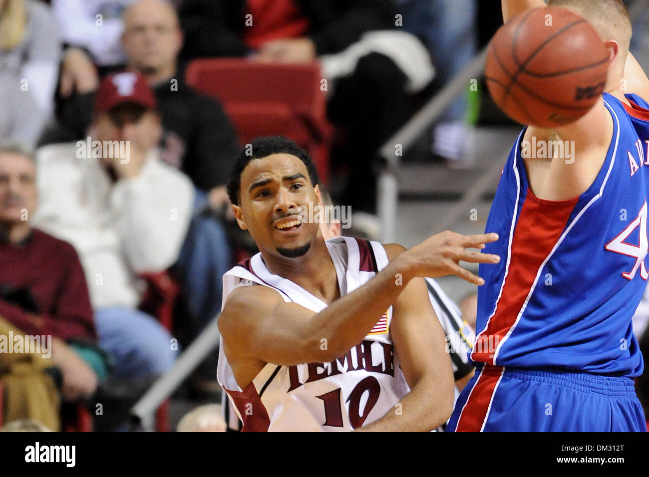Temple guard Luis Guzman #10 passes past Kansas center Cole Aldrich #45 ...