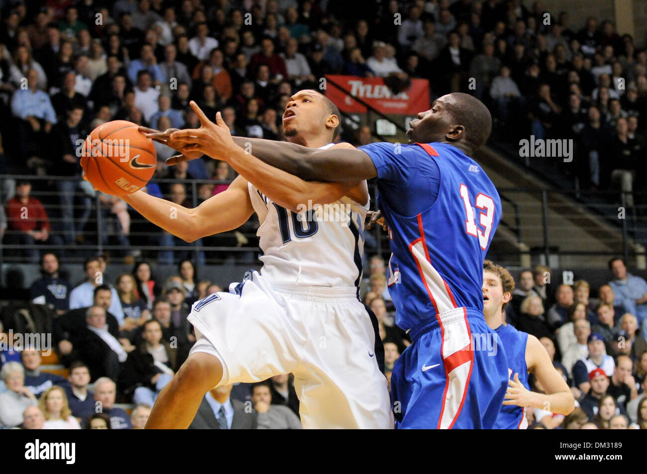 Villanova guard Corey Fisher #10 drives the lane while being defended ...