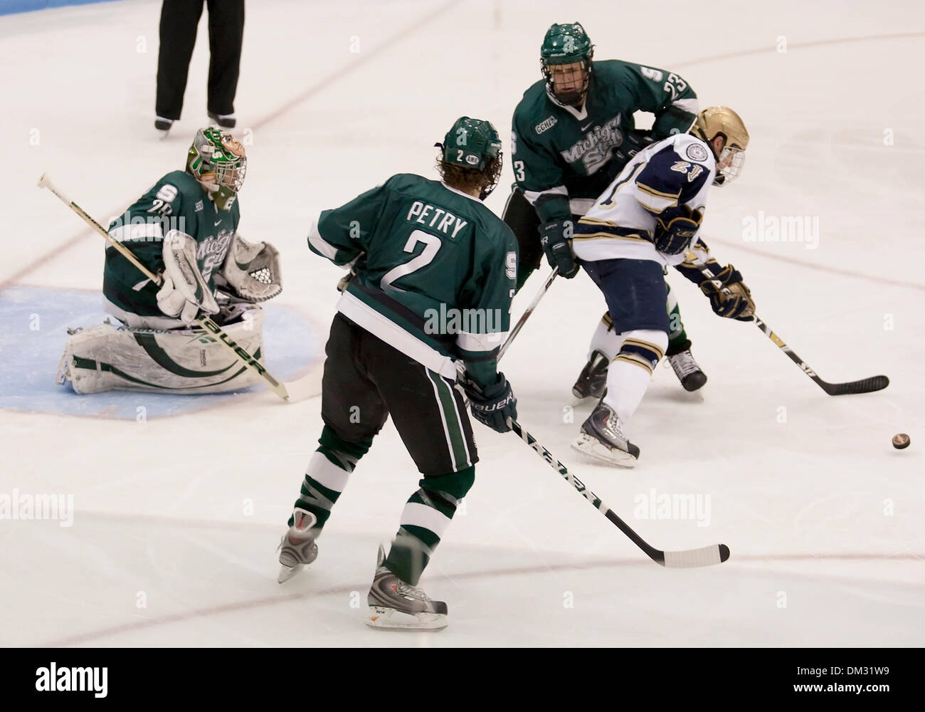 Michigan State Defensemen Jeff Petry (2), Matt Grassi (23), and Notre ...