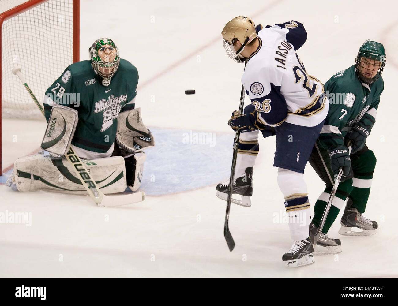 Notre Dame Left Wing Nick Larson (26) and Michigan State Goaltender ...