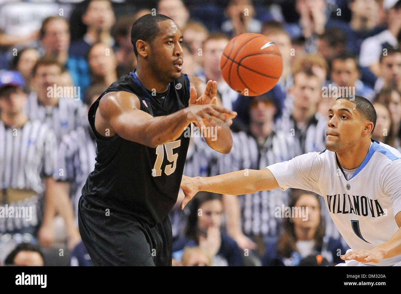 Georgetown guard Austin Freeman #15 passes the ball while being guarded ...