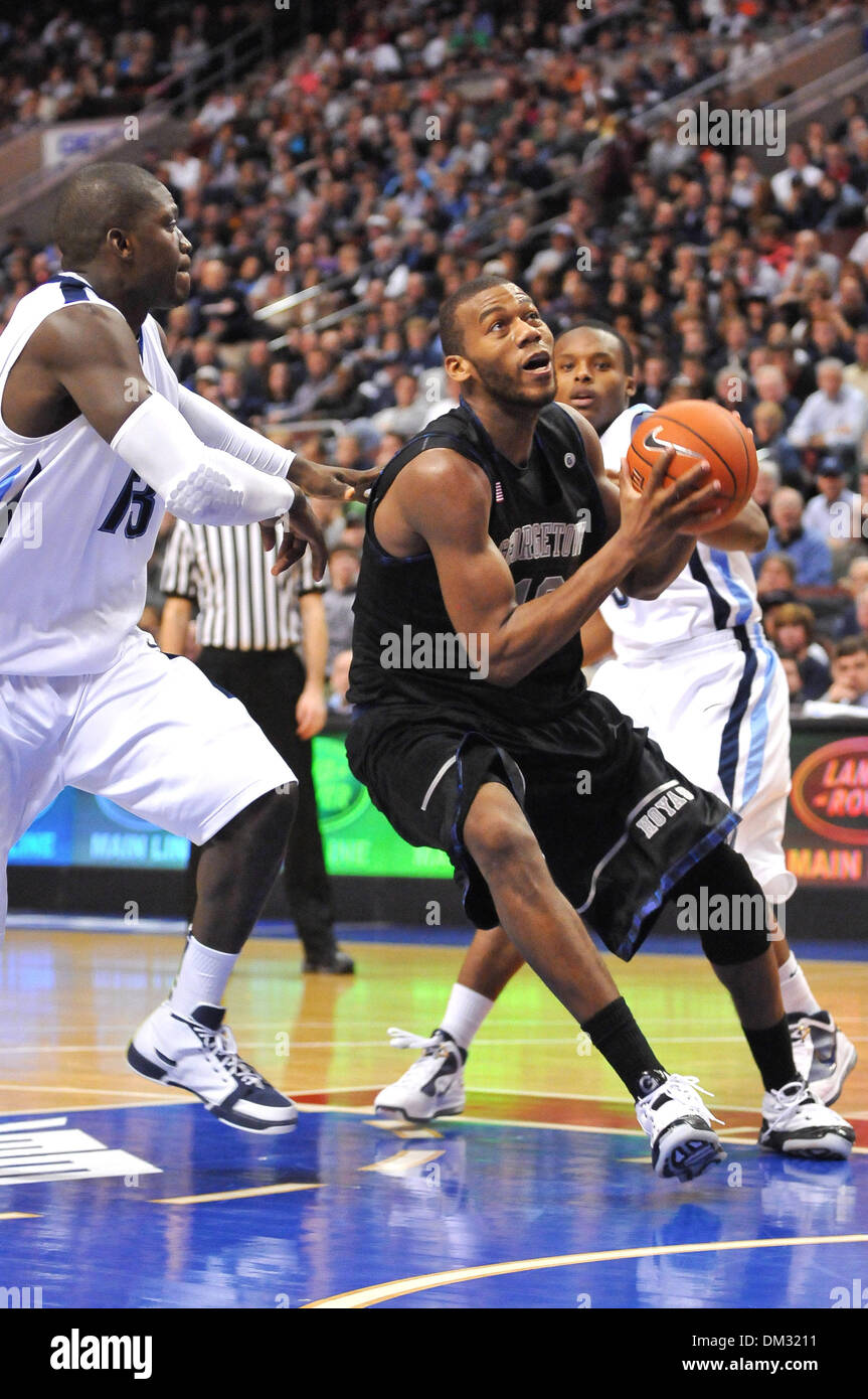 Georgetown center Greg Monroe #10 drives the basket while being guarded ...
