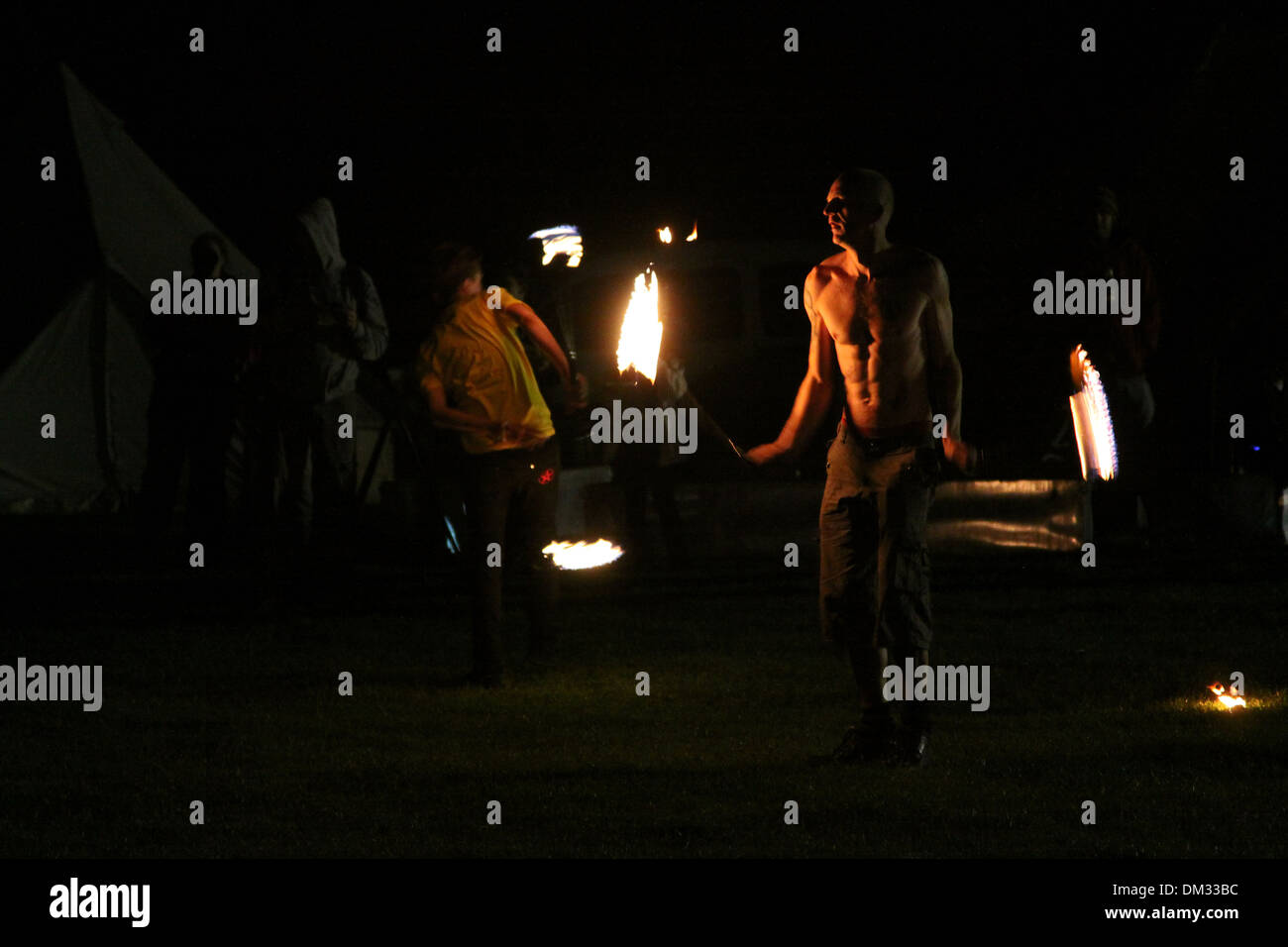 A man fire spinning poi Stock Photo - Alamy