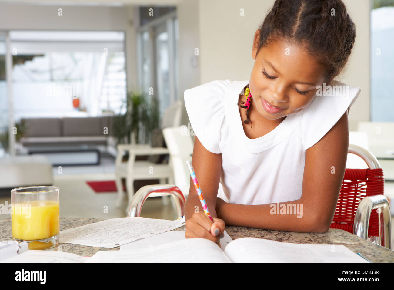 Girl Doing Homework In Kitchen Stock Photo - Alamy
