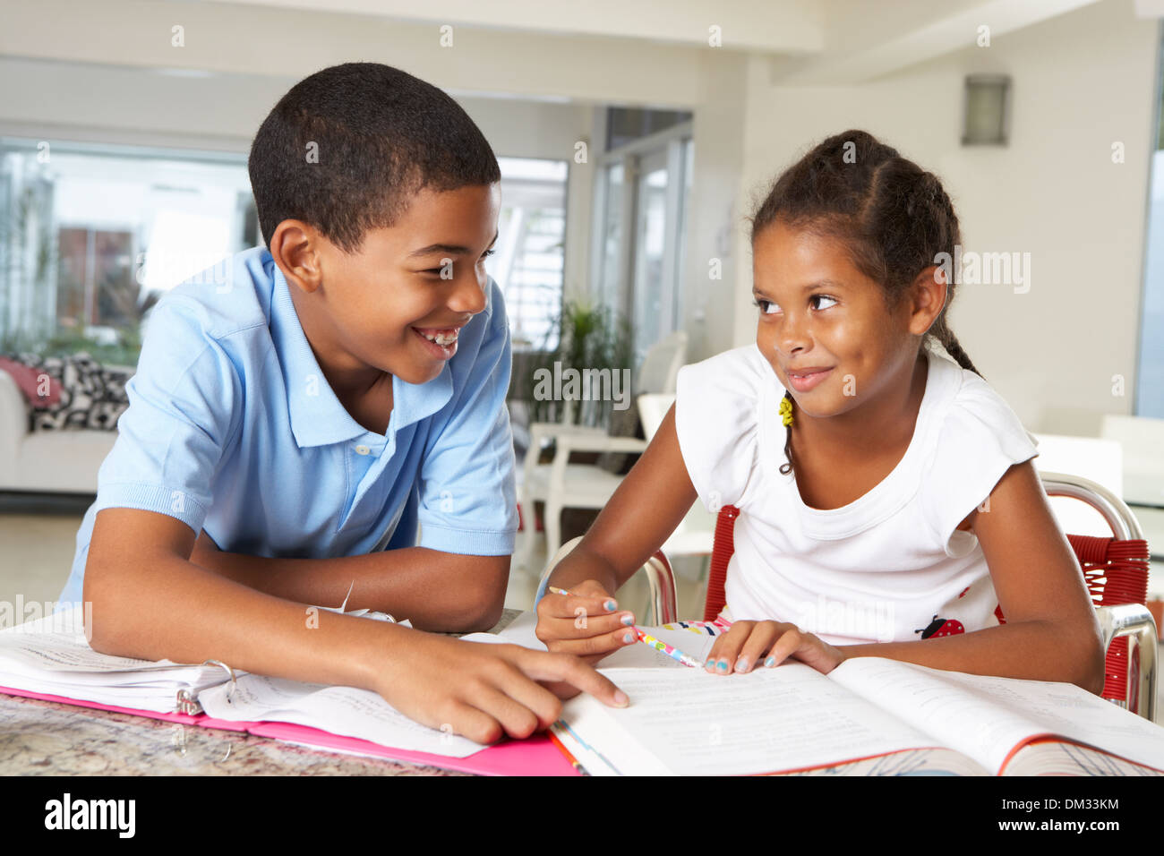 Two Children Doing Homework Together In Kitchen Stock Photo - Alamy