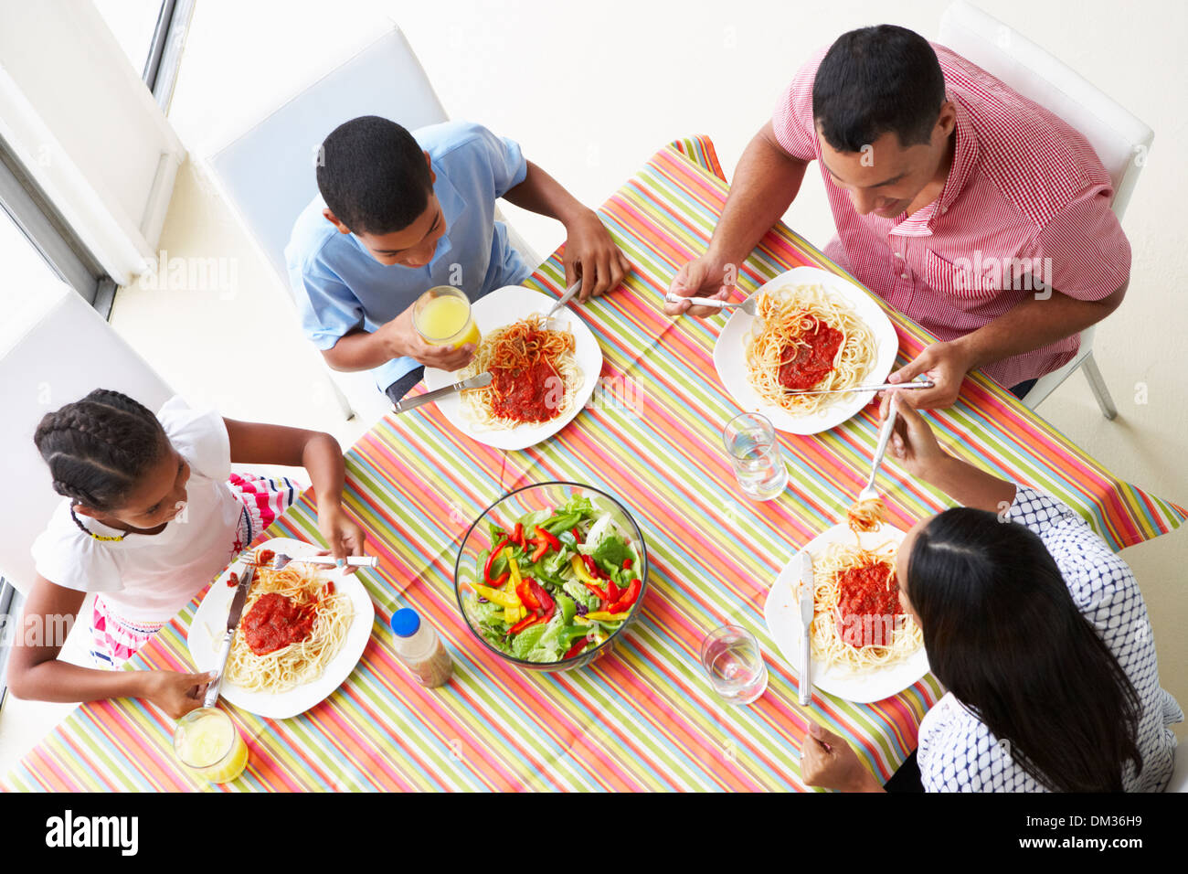 Overhead View Of Family Eating Meal Together Stock Photo - Alamy