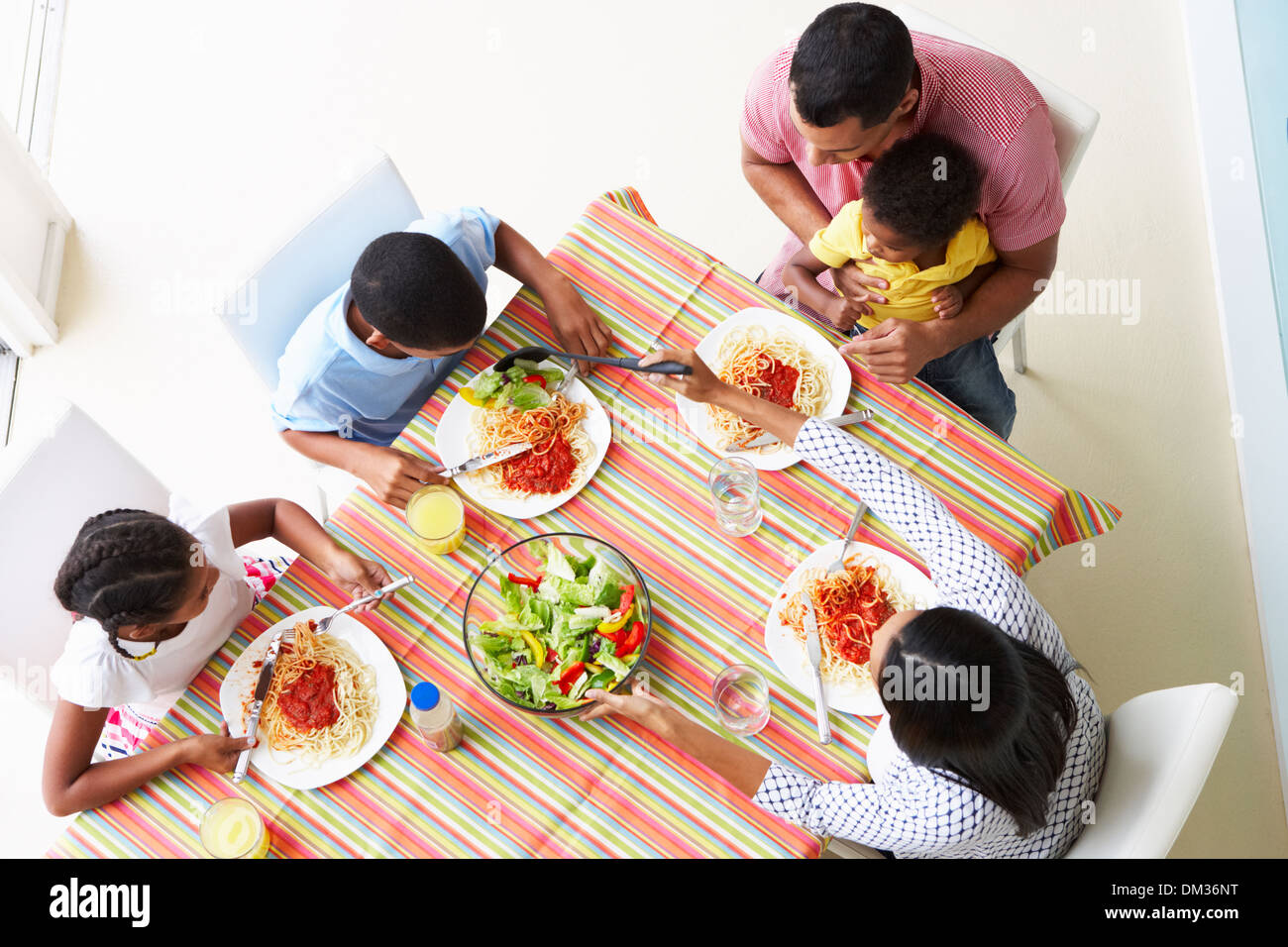 Overhead View Of Family Eating Meal Together Stock Photo - Alamy