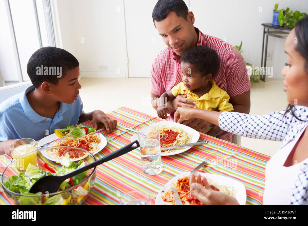 Family Eating Meal Together At Home Stock Photo - Alamy