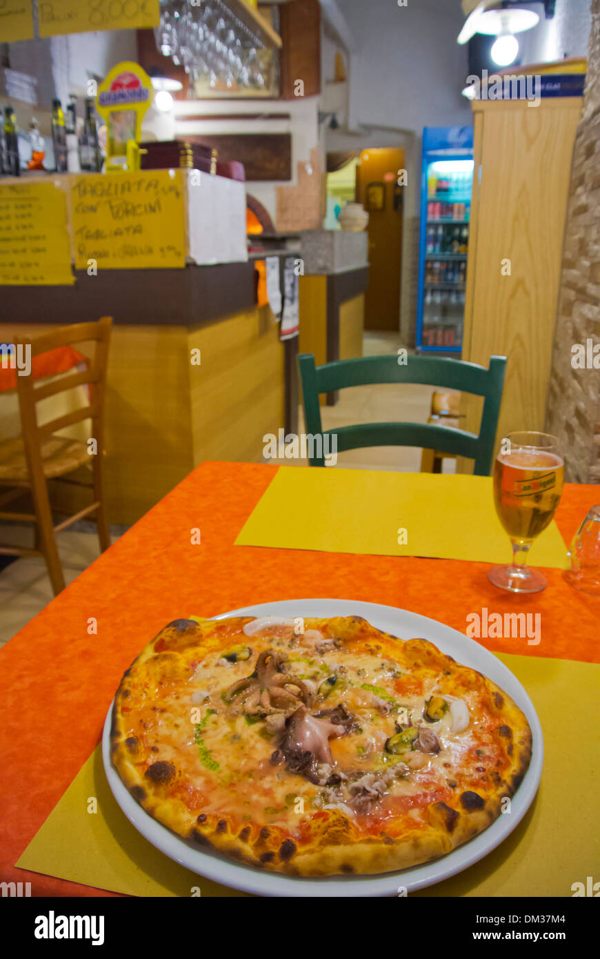 Pizza Frutti di Mare with seafood and beer Pisa city Tuscany region ...