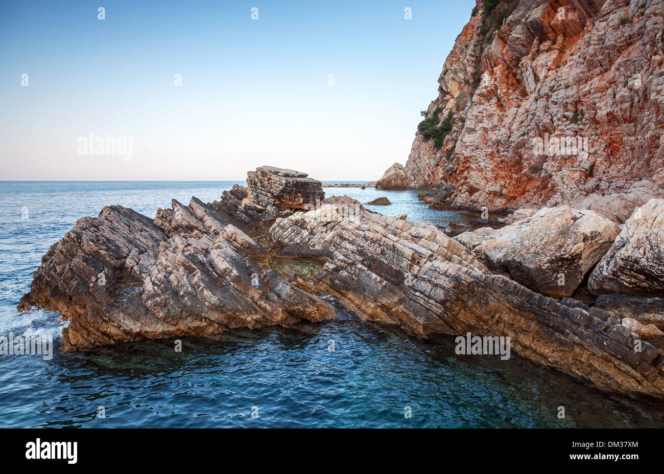Red coastal rocks in Adriatic Sea, Montenegro Stock Photo - Alamy