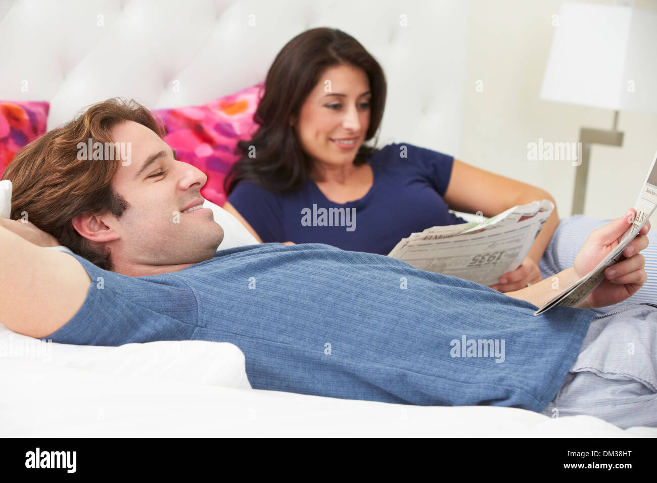 Couple in bed snuggling reading hi-res stock photography and images - Alamy