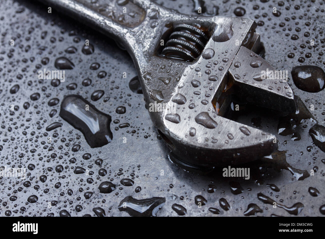 Adjustable spanner in water drops close up Stock Photo - Alamy