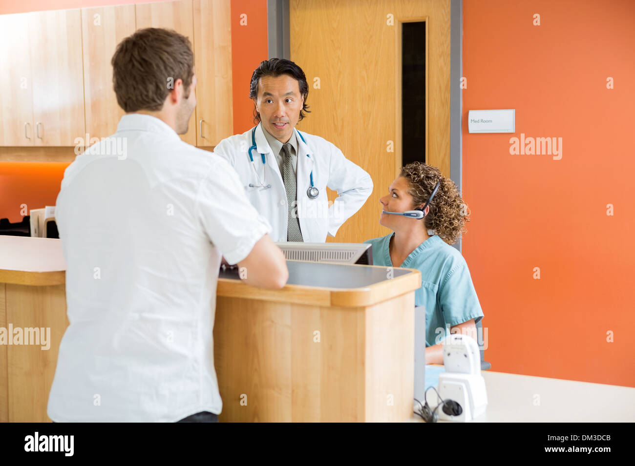 Asian male reception desk hi-res stock photography and images - Alamy