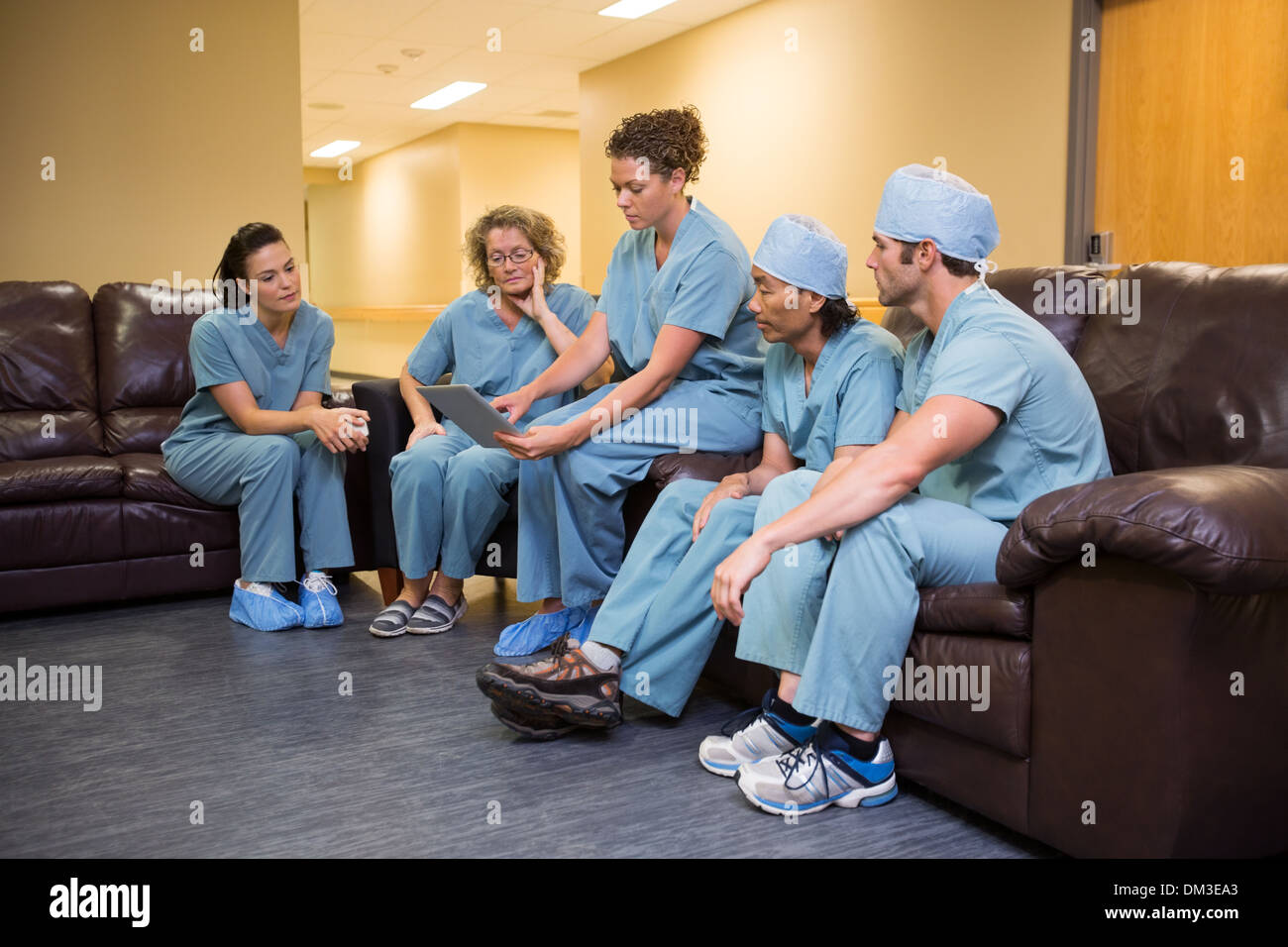 Medical Team Using Digital Tablet In Hospital's Waiting Room Stock ...