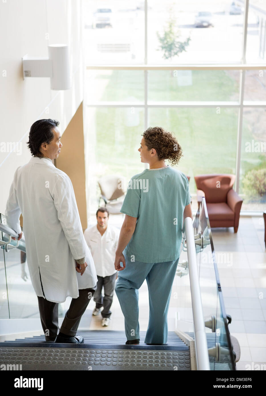 Medical Team And Patient Walking On Stairs Stock Photo - Alamy