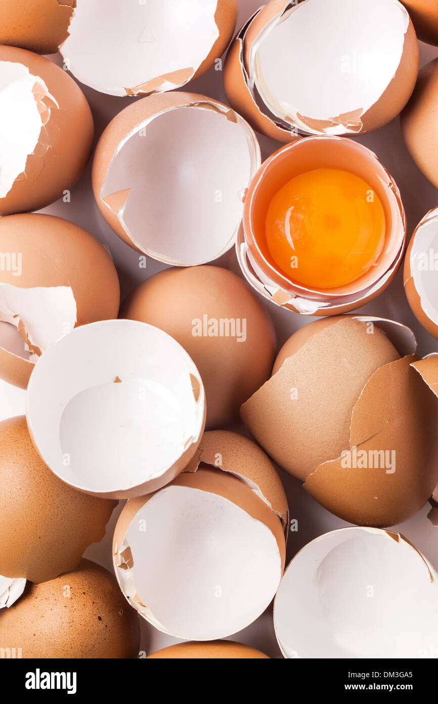 Background with top view on broken empty egg shell and one yolk Stock Photo - Alamy