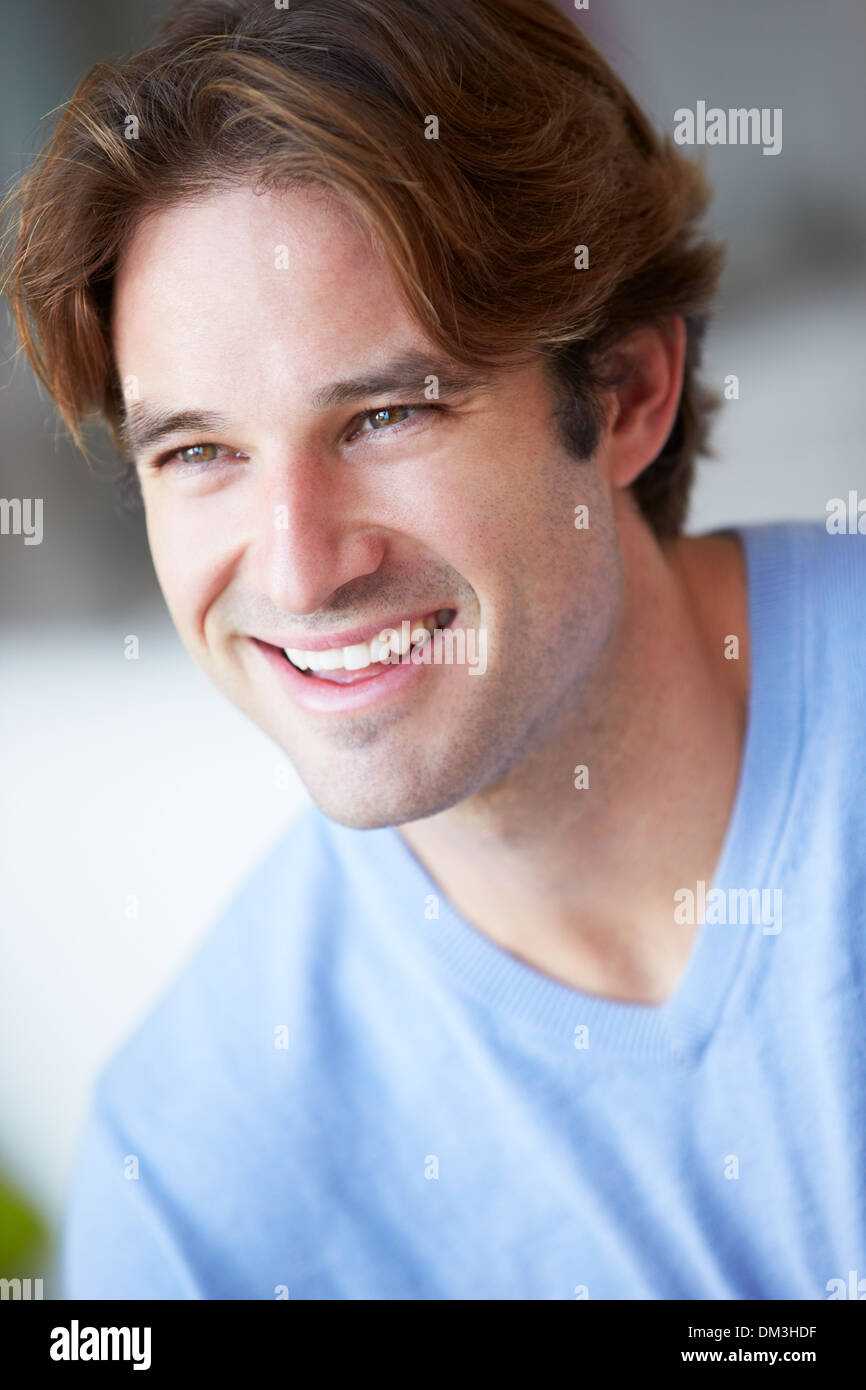 Smiling Man Sitting On Sofa Stock Photo - Alamy