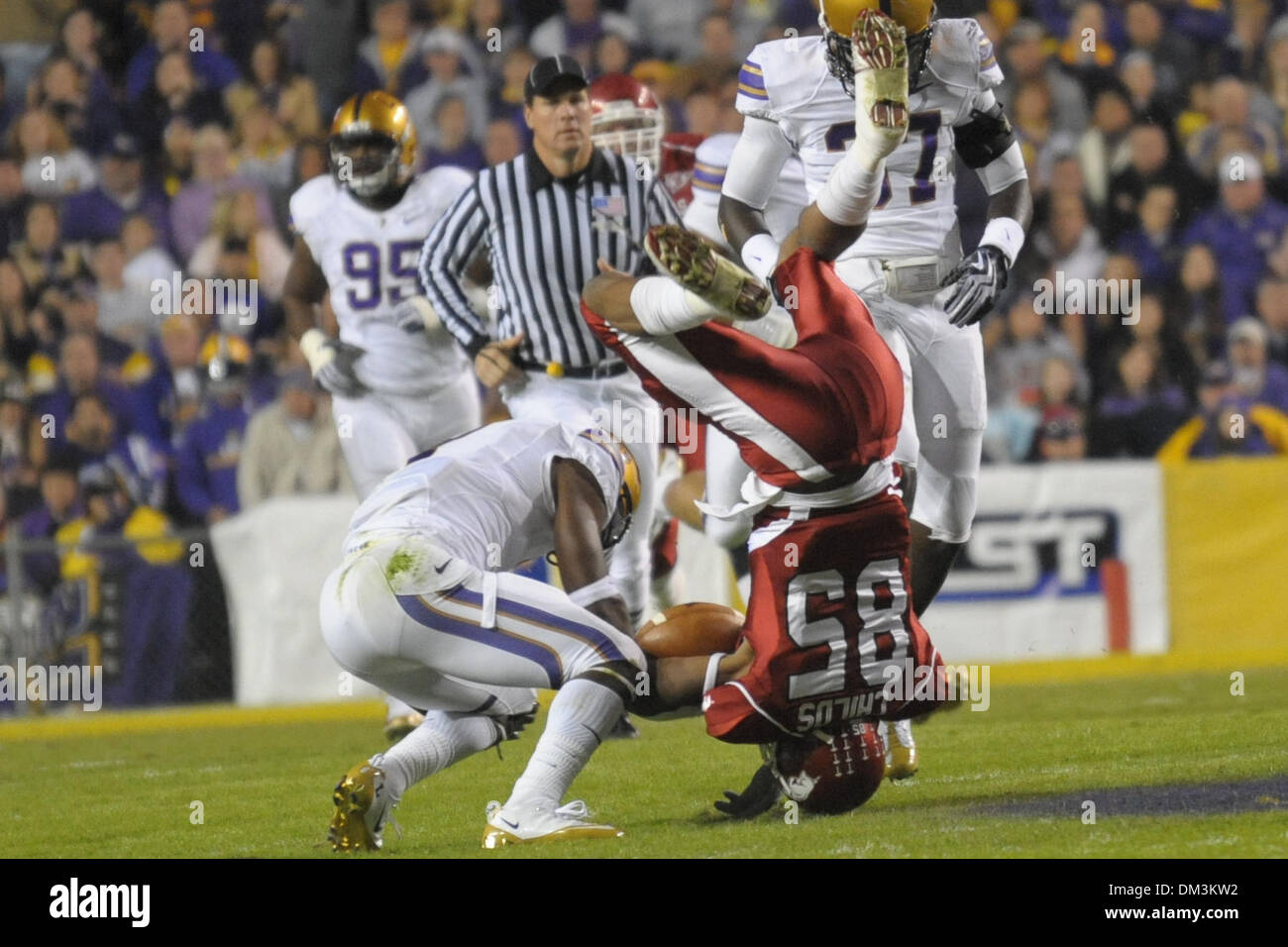 Arkansas wide receiver, #85 Greg Childs, is flipped upside down during ...