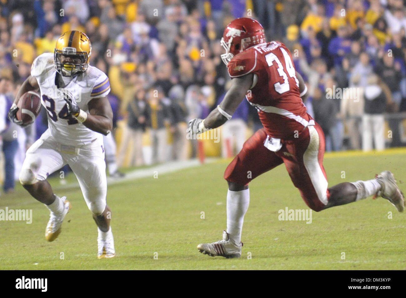 LSU running back, #34 Stevan Ridley, is pursued by Arkansas linebacker ...