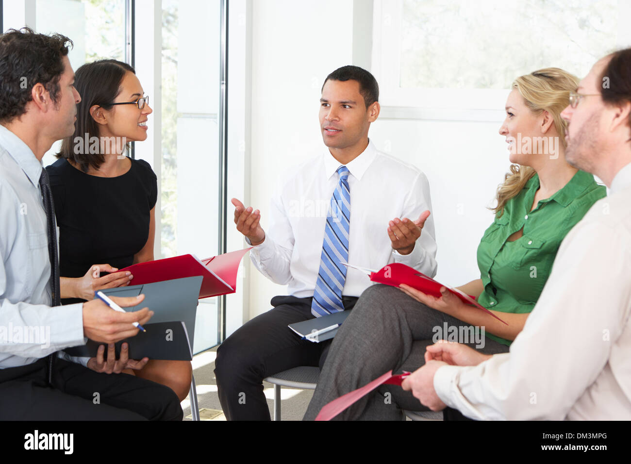 Businesspeople Having Informal Office Meeting Stock Photo - Alamy