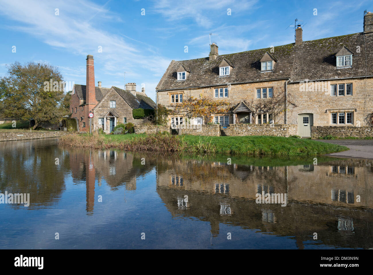The old mill at Lower Slaughter in the Cotswolds UK reflected in the ...