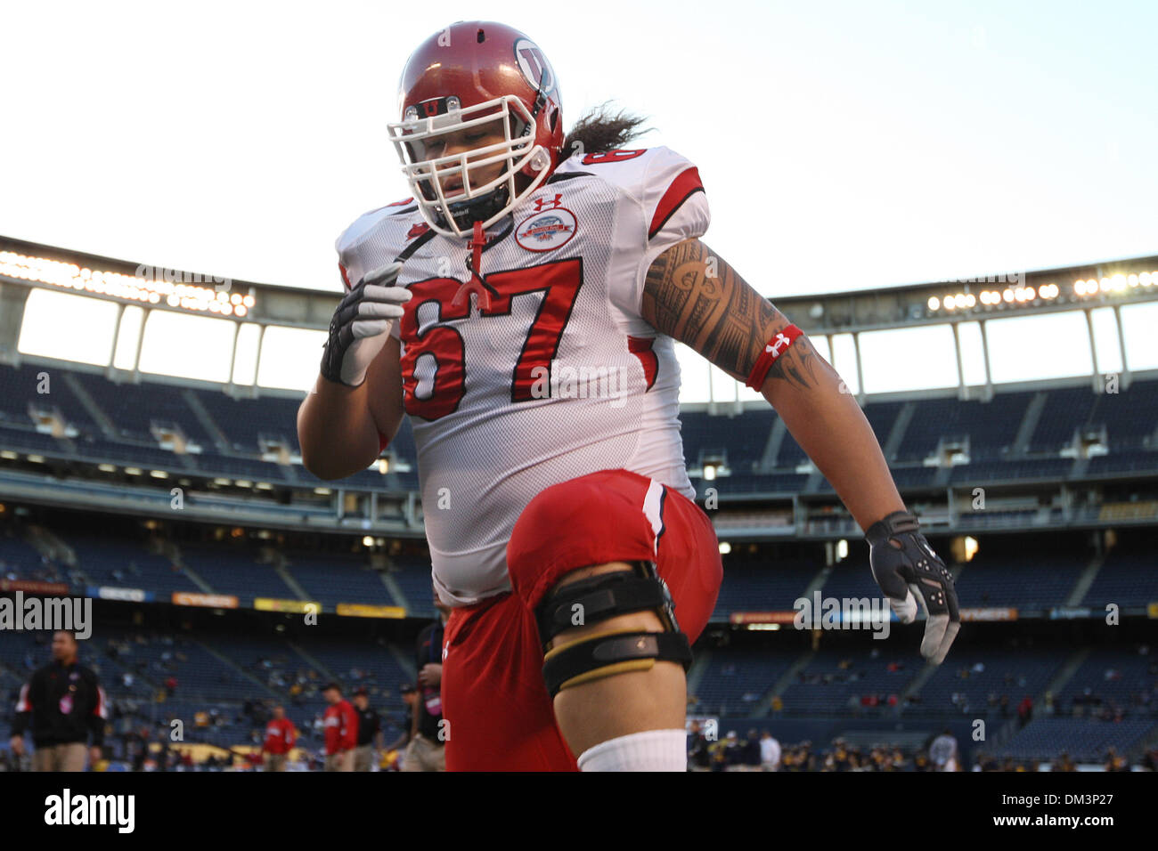 Utah offensive lineman Derek Tuimauga #67 warms up on the sideline ...