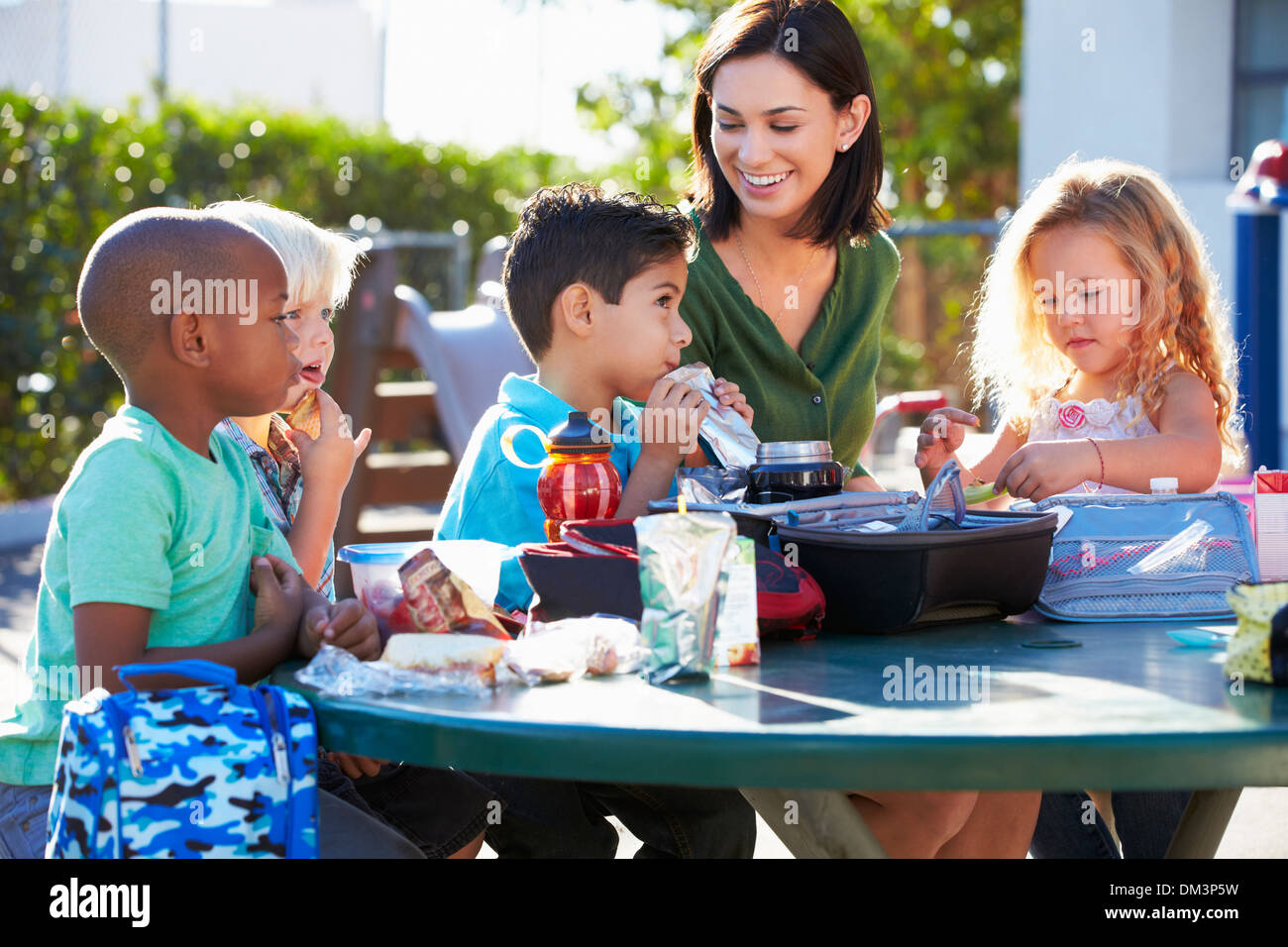 Teacher supervising children hi-res stock photography and images - Alamy
