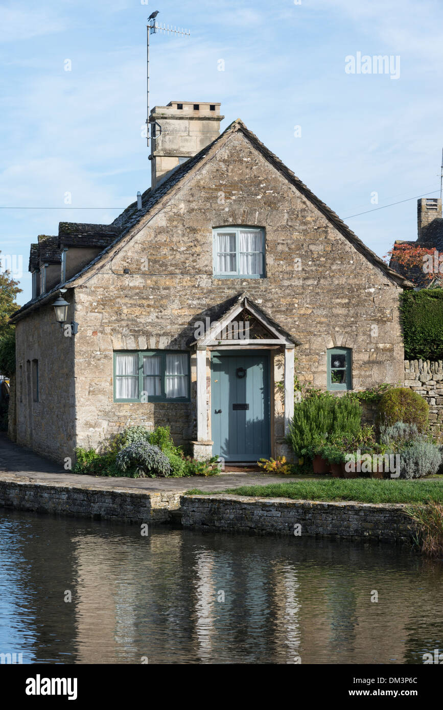 A pretty limestone house by the River Eye in Lower Slaughter in the ...