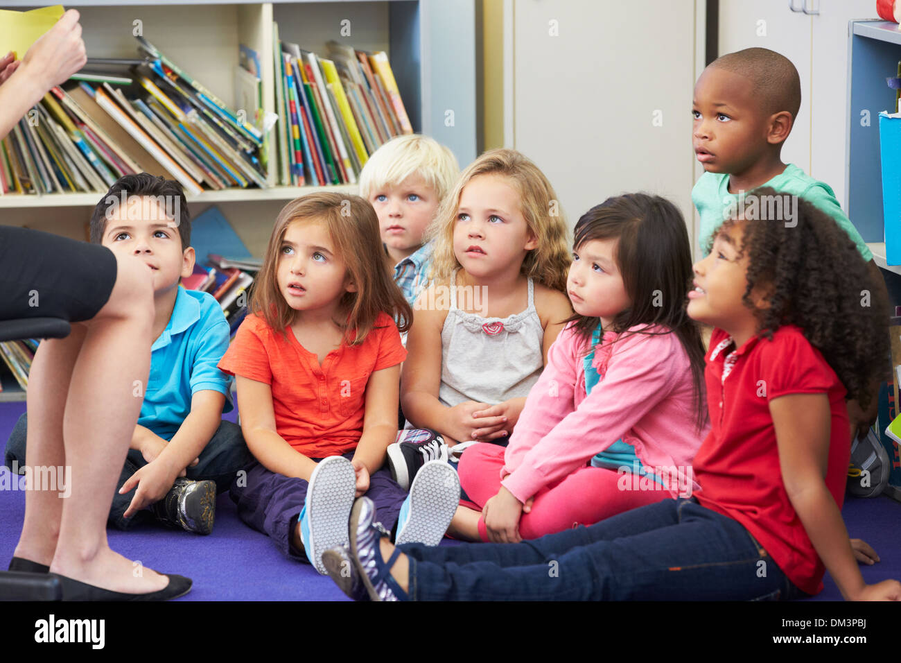 Elementary Pupils In Classroom Working With Teacher Stock Photo - Alamy