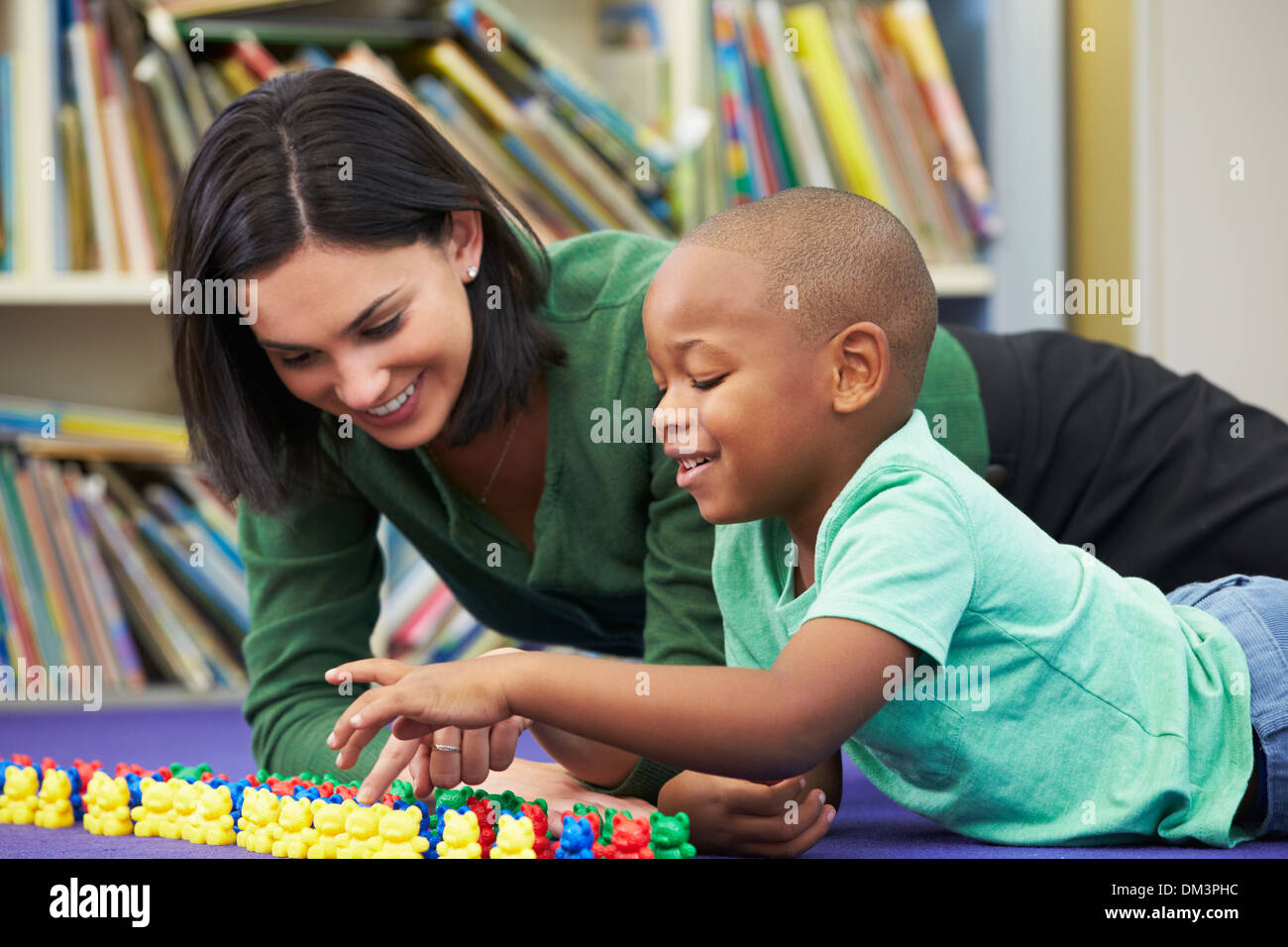 Elementary Pupil Counting With Teacher In Classroom Stock Photo - Alamy