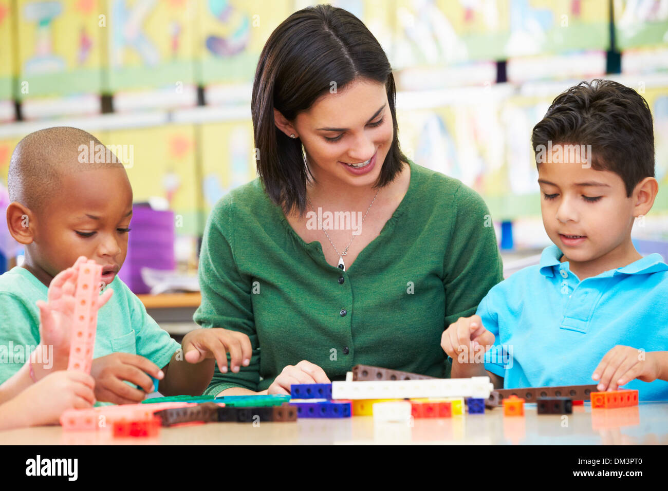 Elementary Pupils Counting With Teacher In Classroom Stock Photo - Alamy