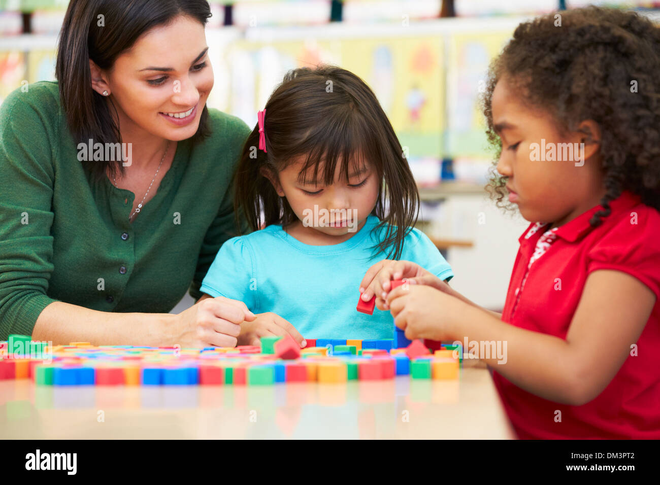 Elementary Pupils Counting With Teacher In Classroom Stock Photo - Alamy