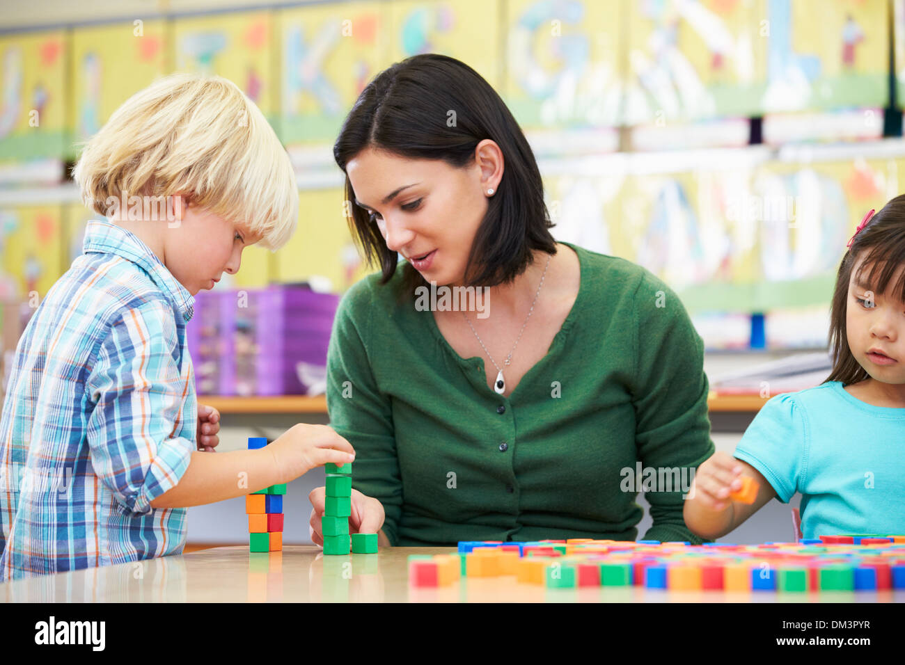 Elementary Pupils Counting With Teacher In Classroom Stock Photo - Alamy