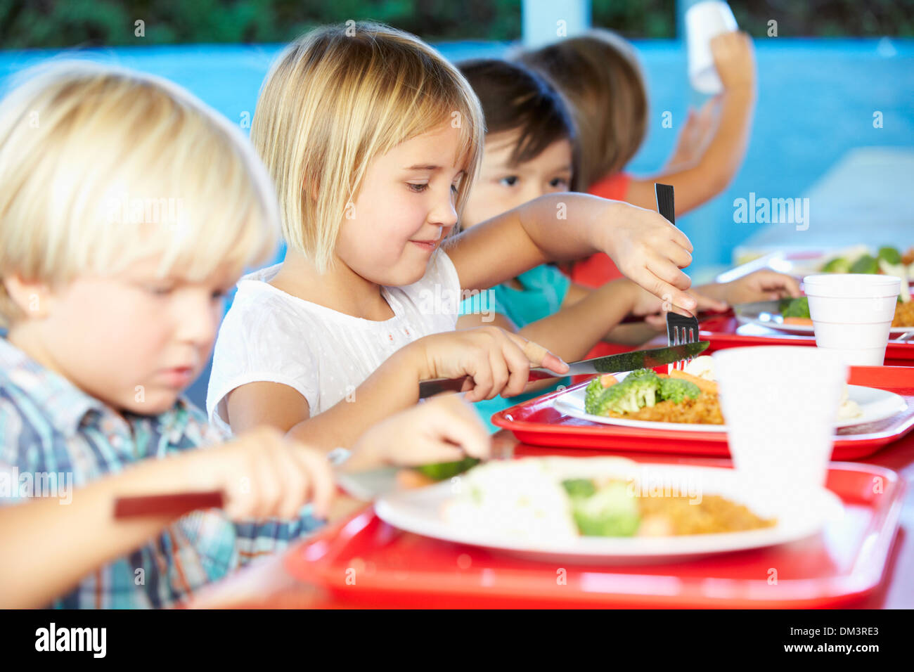 Elementary Pupils Enjoying Healthy Lunch In Cafeteria Stock Photo - Alamy