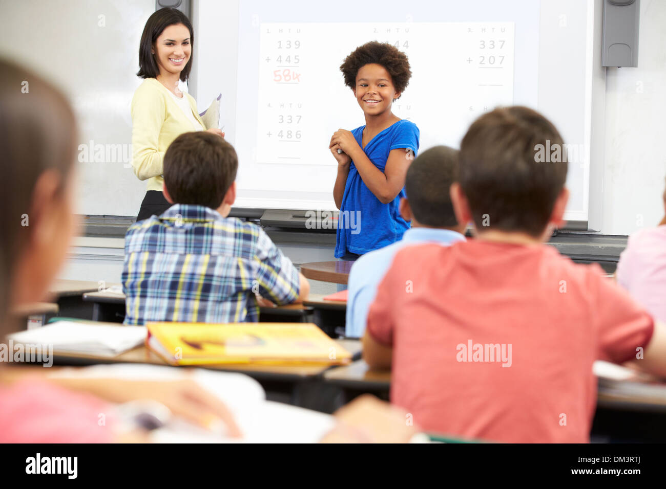 Female Student Writing Answer On Whiteboard Stock Photo - Alamy