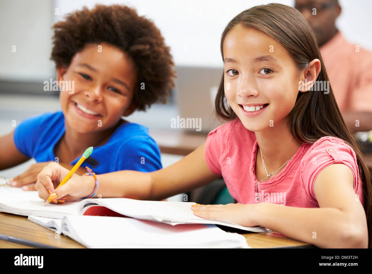Pupils Studying At Desks In Classroom Stock Photo - Alamy