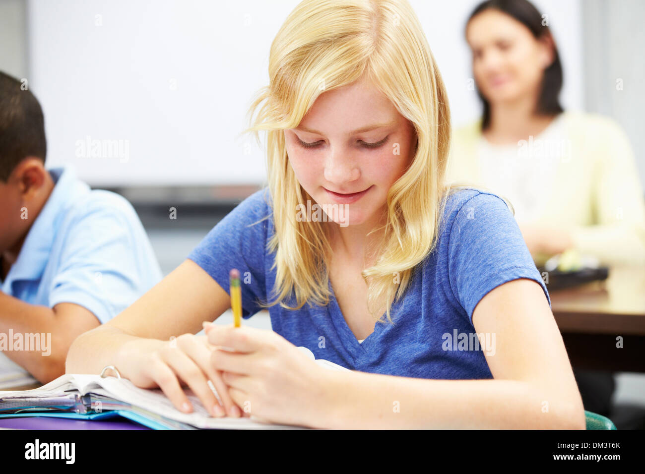 Pupils Studying At Desks In Classroom Stock Photo - Alamy
