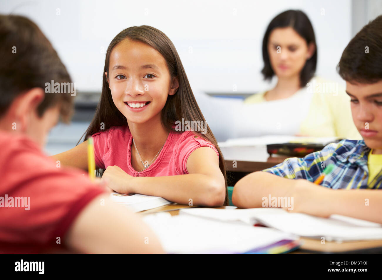 Pupils Studying At Desks In Classroom Stock Photo - Alamy