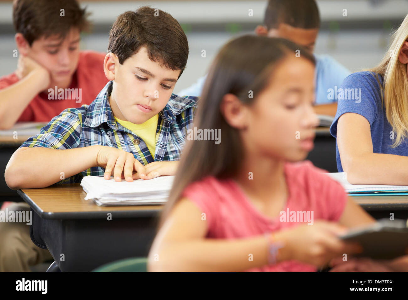 Pupils Studying At Desks In Classroom Stock Photo - Alamy