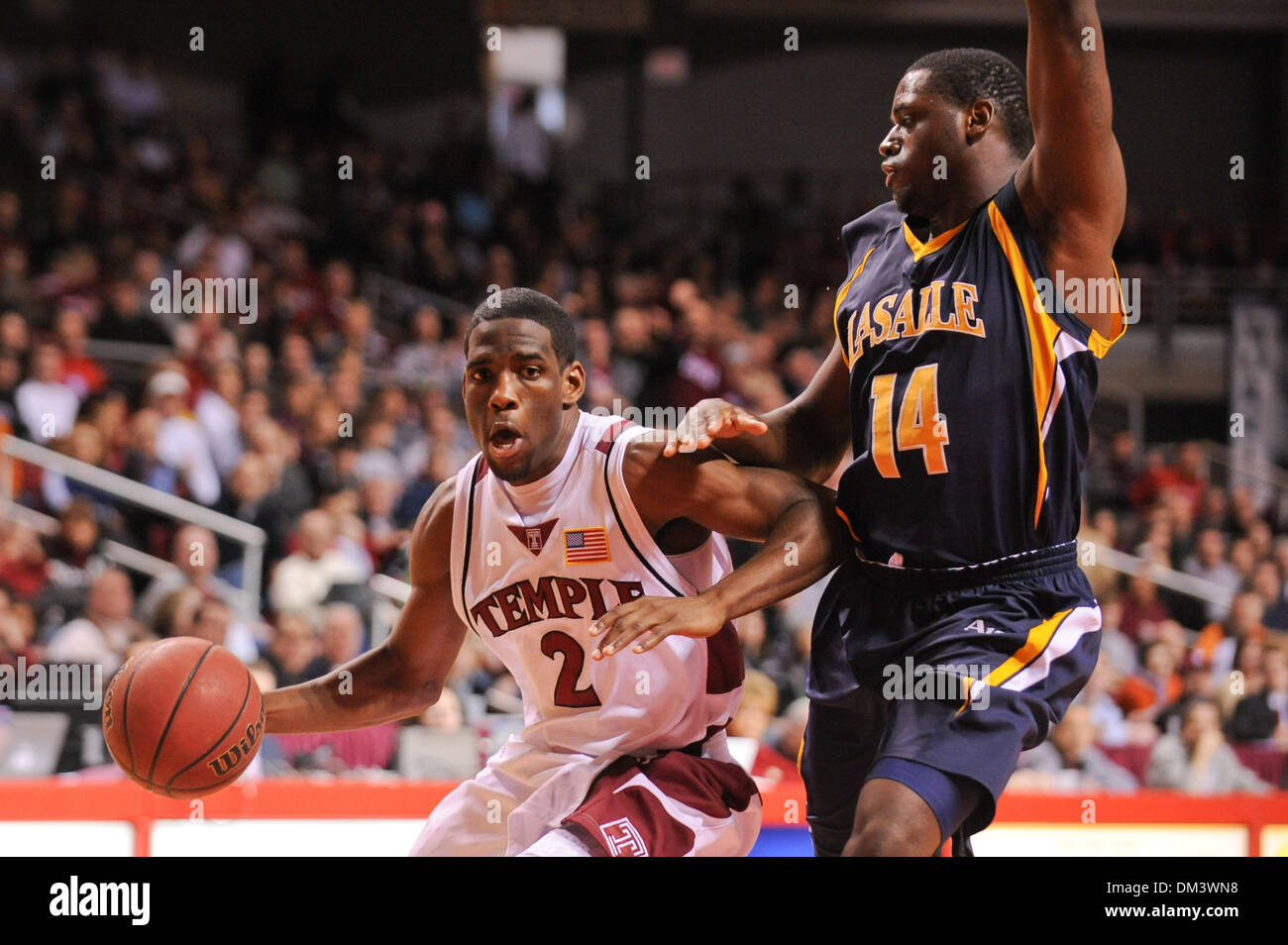 Temple guard Ryan Brooks #2 drives past La Salle center Devon White #14 ...