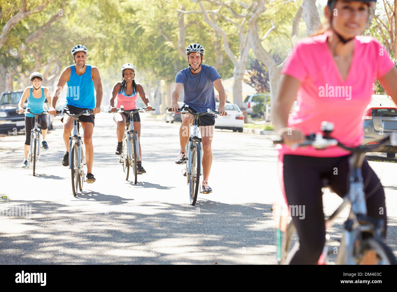 Group Of Cyclists On Suburban Street Stock Photo - Alamy